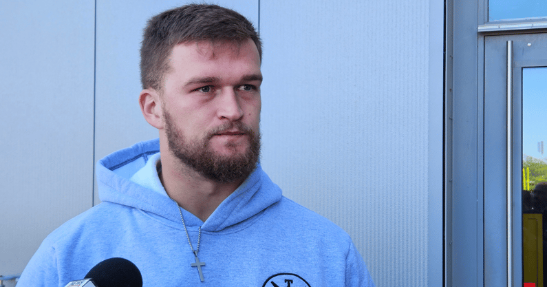 Logan Lee on the line meeting and facing Wisconsin