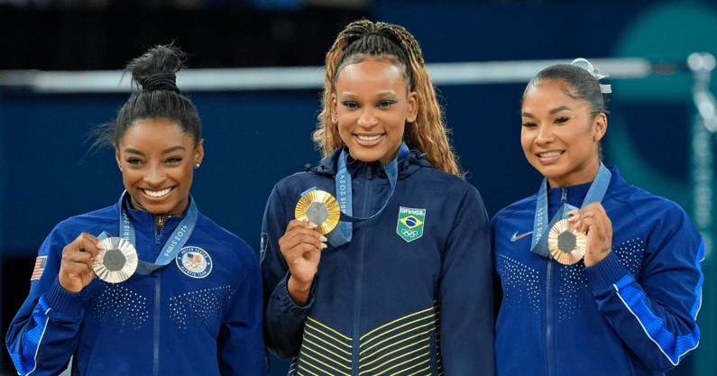 Simone Biles, Jordan Chiles bow down to Rebeca Andrade on podium during ... Simone Biles, Jordan Chiles bow down to Rebeca Andrade on podium during ...