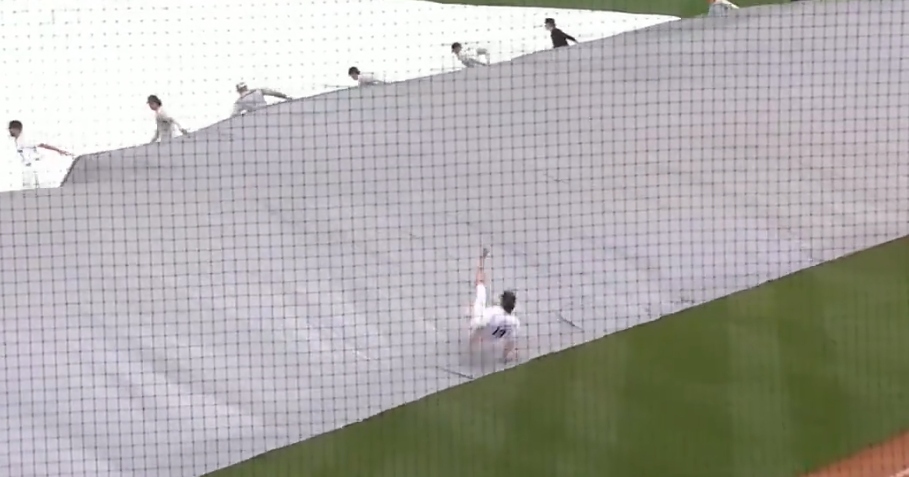 Georgia pitcher Ethan Sutton wipes out while removing weather delay ...